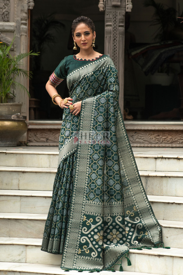 Dark green color tussar silk saree with woven design