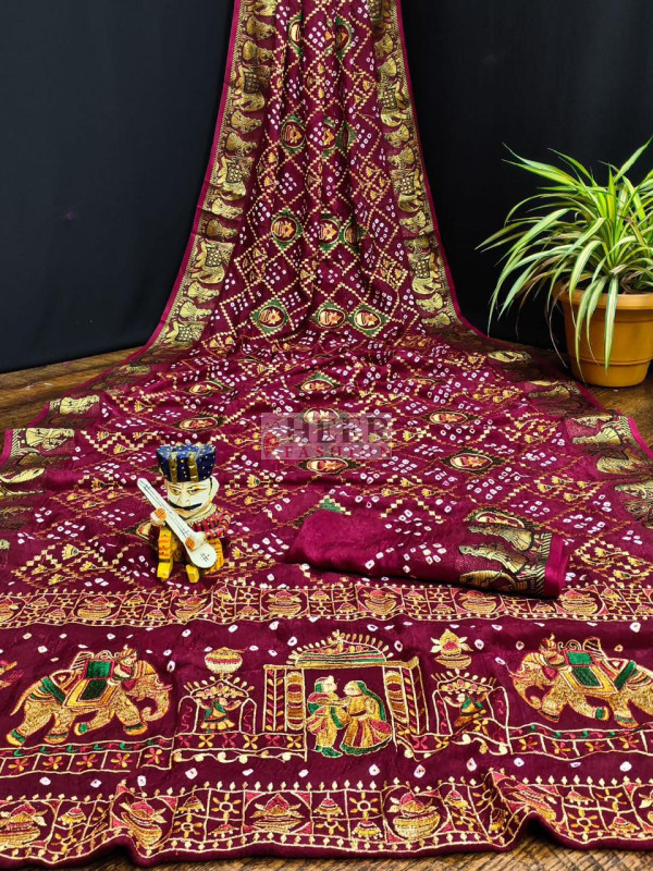 Maroon color pure hand bandhej silk saree with zari weaving work