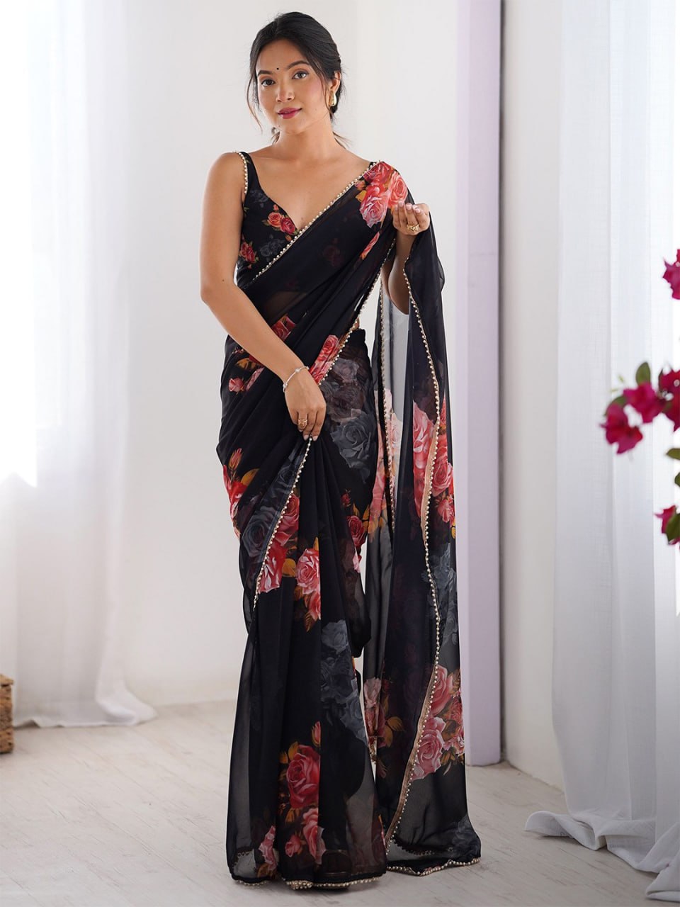 Black color georgette saree with printed work and moti border