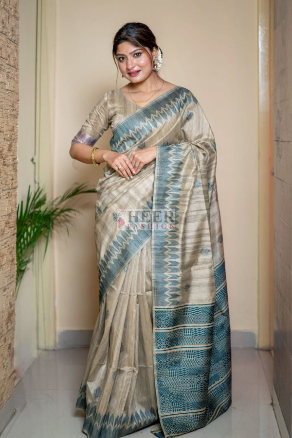Beige and rama green color tussar silk saree with woven design